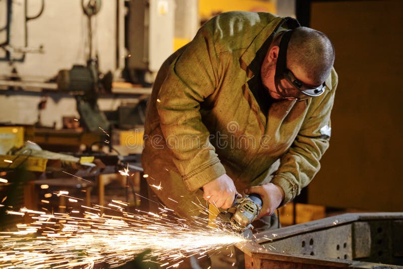 Worker using grinder stock image. Image of adult, standing - 208604731