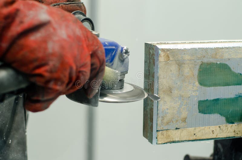 Worker using a grinder stock photo. Image of grinders - 141110542