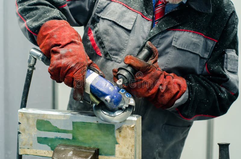 Worker using a grinder stock photo. Image of circular - 141110854