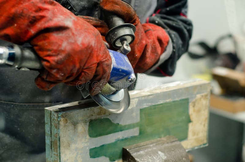 Worker using a grinder stock image. Image of construction - 141110567