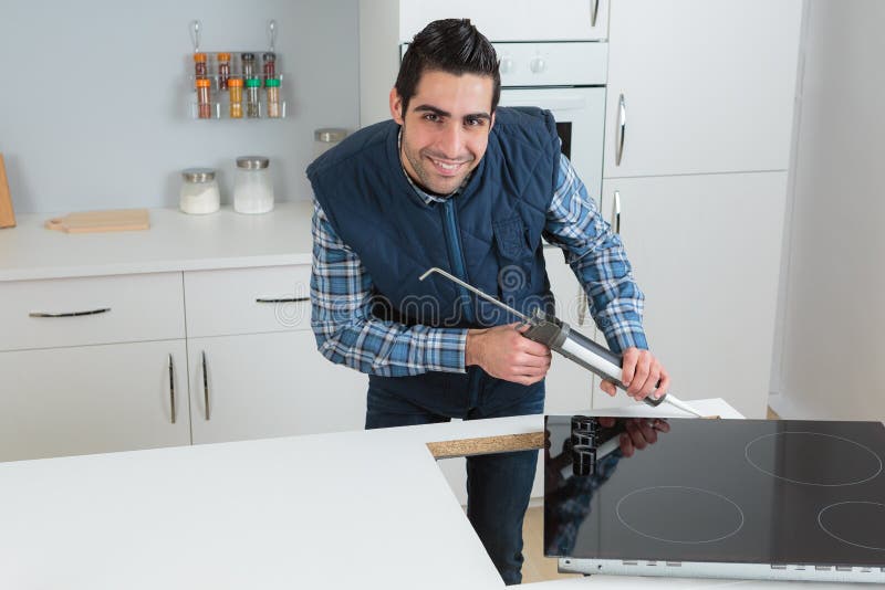 Worker Using Gun with Silicone Stock Photo - Image of tool, kitchen ...