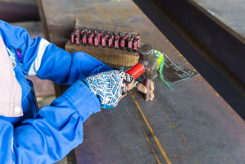 Worker are Using a Hammer To Stamp Characters and Number with Steel ...