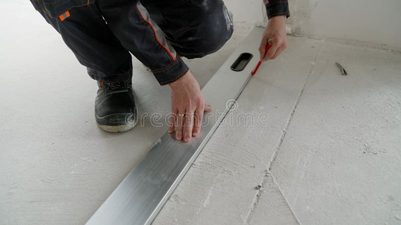Worker Using an Industrial Pencil To Measure and Mark Ceramic Tiles at ...
