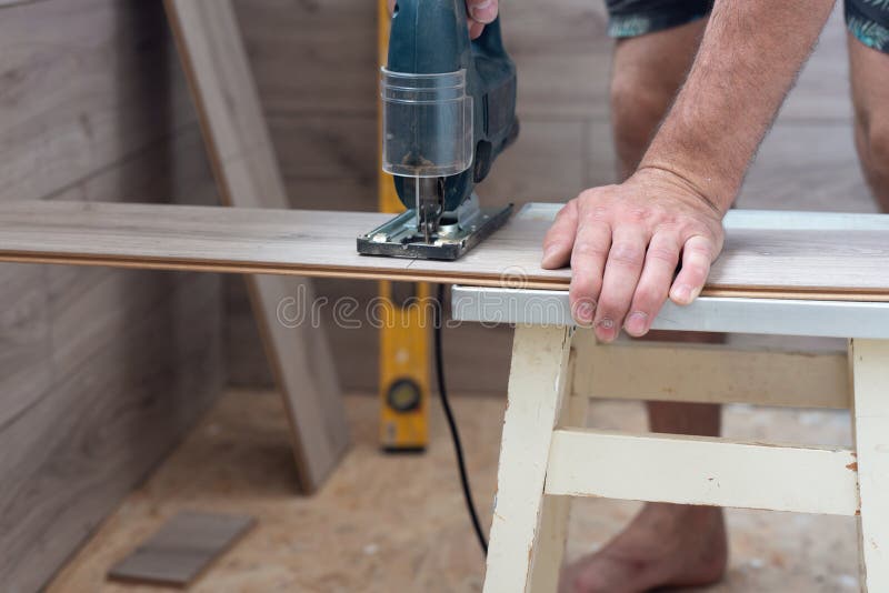 A Worker Using a Jigsaw Saws Laminate Boards Stock Image - Image of ...