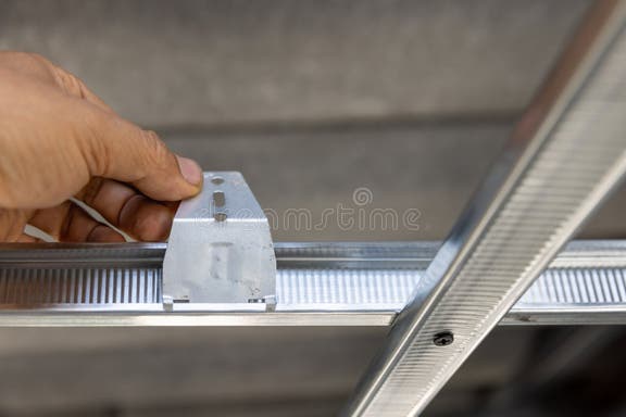 Worker is Using Locking Keys To Lock Top Cross Rails To Furring ...