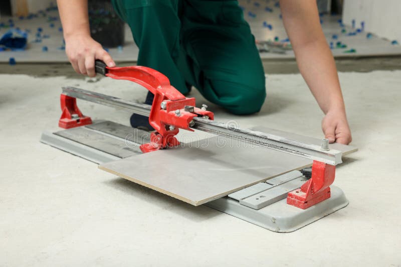 Worker Using Manual Tile Cutter on Floor, Closeup Stock Image - Image ...
