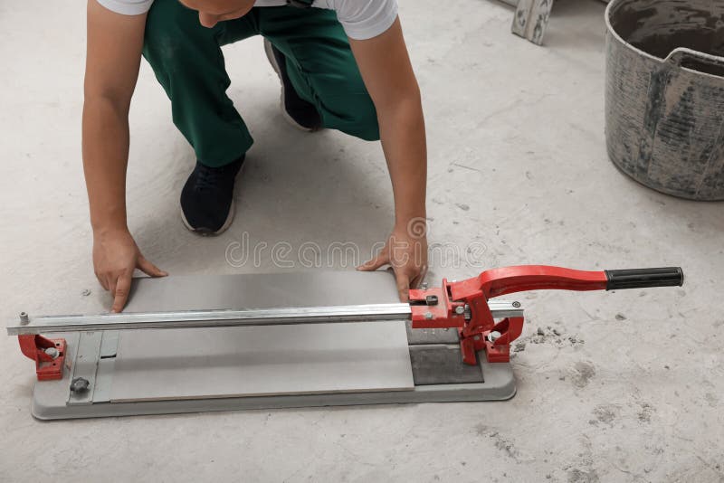 Worker Using Manual Tile Cutter on Floor, Closeup Stock Photo - Image ...