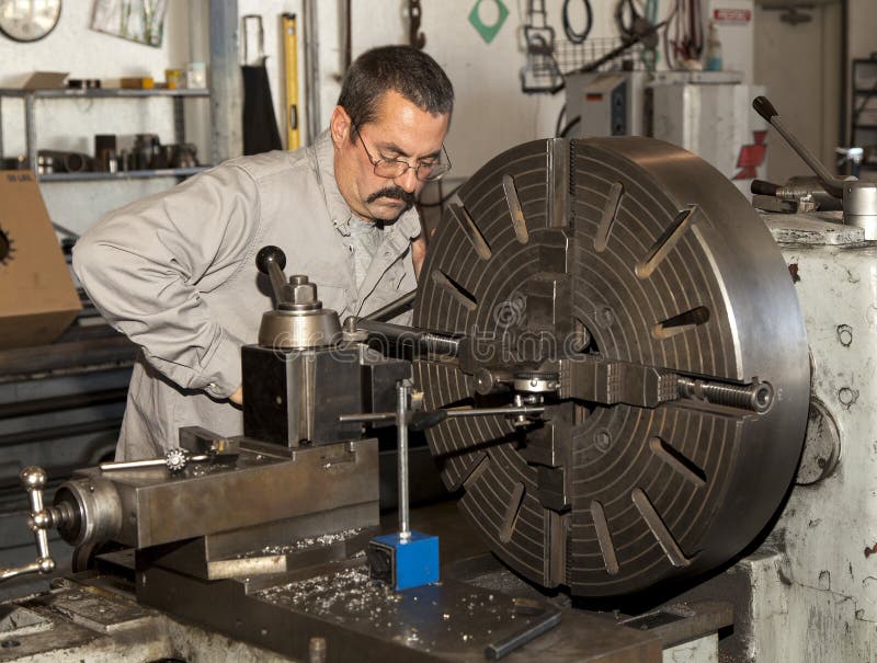 Worker using a Metal Lathe stock photo. Image of worker - 26348502