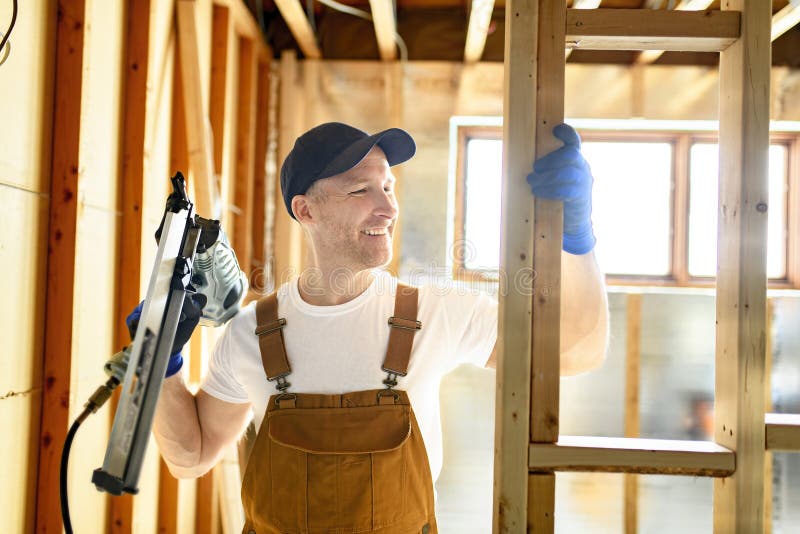 Worker Using Nail Gun To Build Basement Room Stock Image - Image of ...
