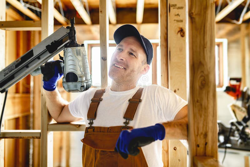Worker Using Nail Gun To Build Basement Room Stock Image - Image of ...