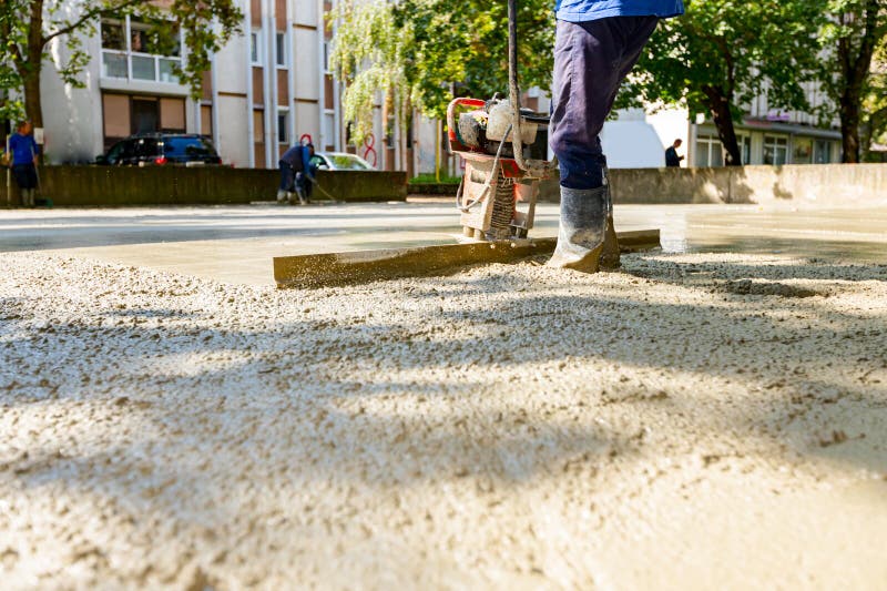 Worker is Using Power Tool with Engine, Compactor, for Level and ...