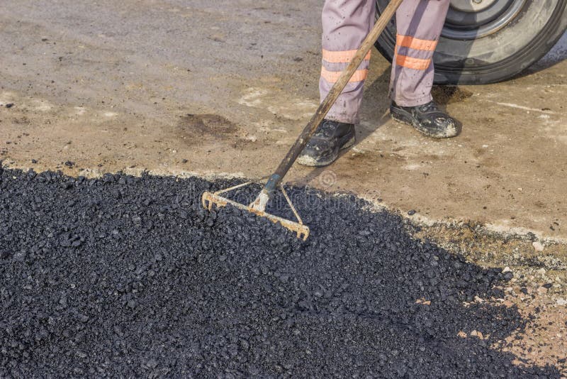 Worker Using Rake To Level Asphalt Pavement Stock Photo - Image of ...