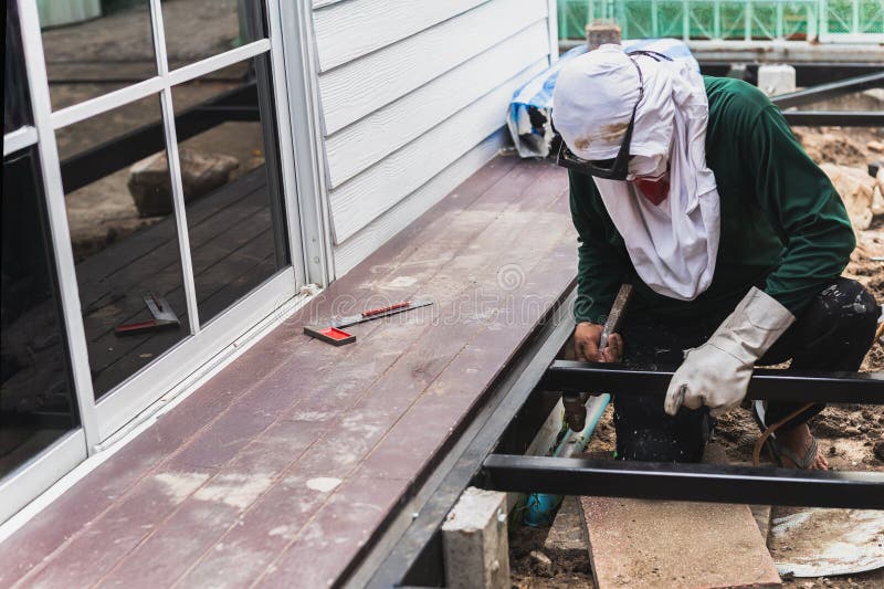 Worker Using Rubber Hammer on Metal Frame at Construction Site. Stock ...