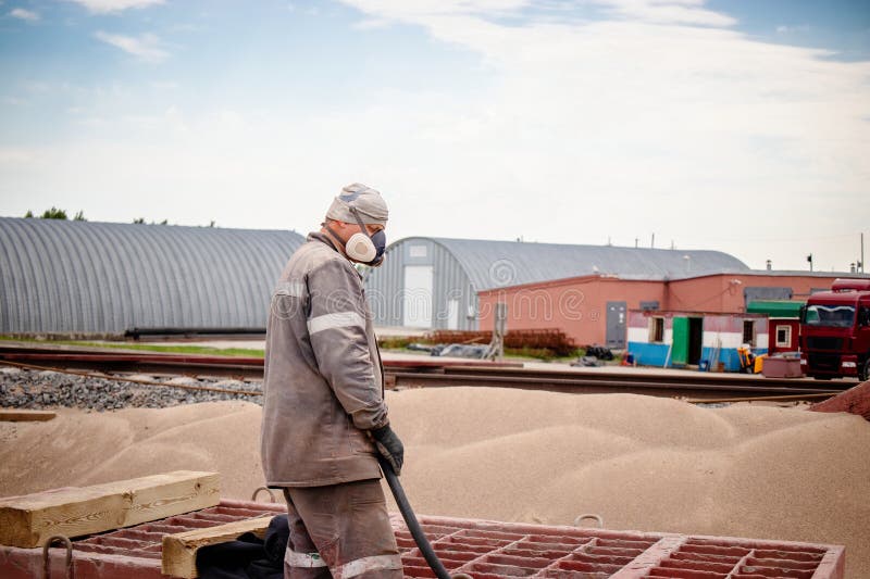 Worker Using a Sandblaster To Remove Rust from a Metal Structure at an ...