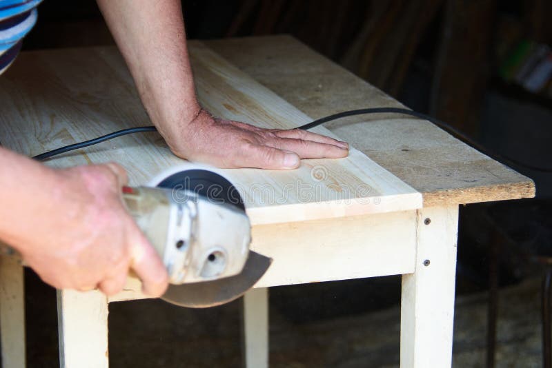 A Worker Using a Sanding Machine Works with Wood in a Carpenter`s ...