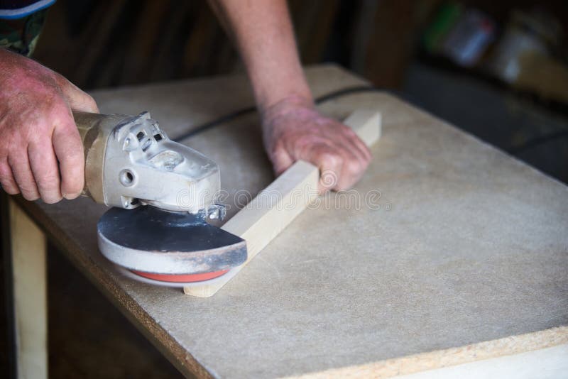 A Worker Using a Sanding Machine Works with Wood in a Carpenter`s ...