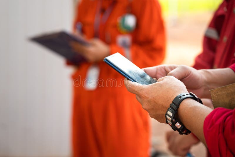 A Worker is Using Smartphone during Safety Audit. Stock Image - Image ...