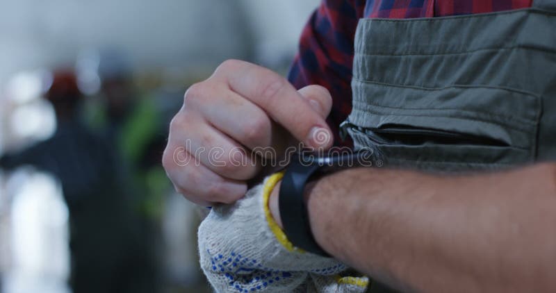 Worker Using Smartwatch in a Warehouse Stock Video - Video of watch ...