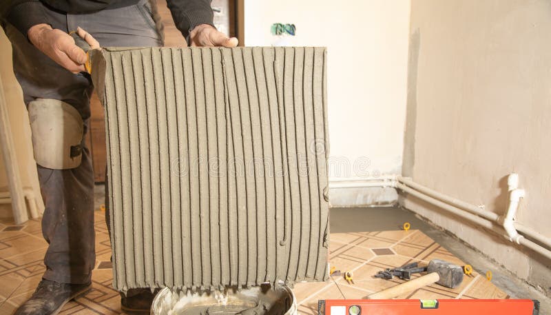 Worker Using Spatula and Putting Glue on Ceramic Tile Stock Image ...