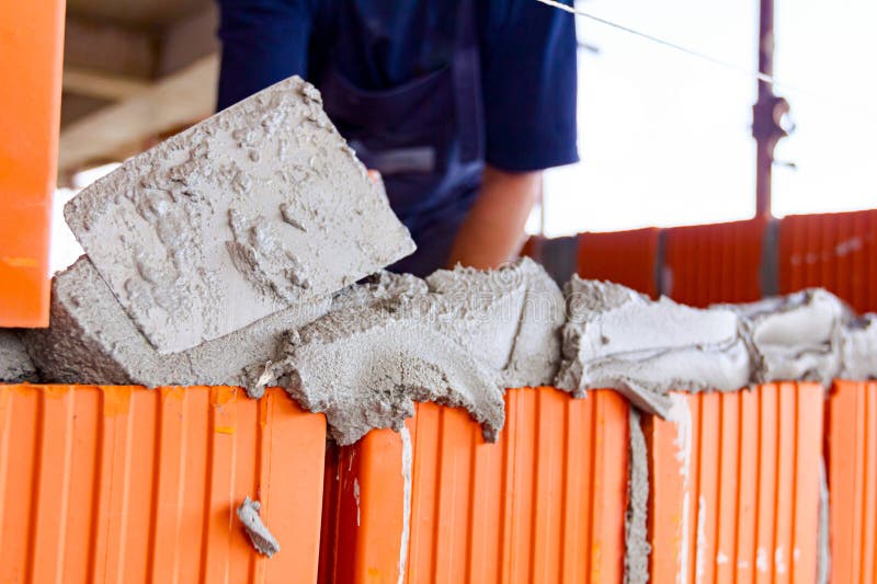 Builder Using Spatula To Set Up Mortar Over Red Brick, Building Site ...