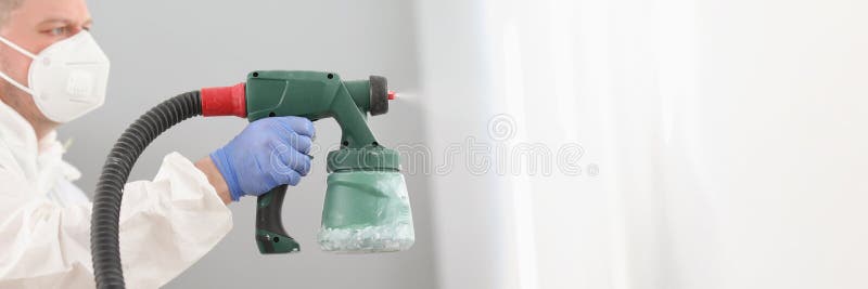 Worker Using Spray Gun for Coloring Wall in White. Effective and Fast ...