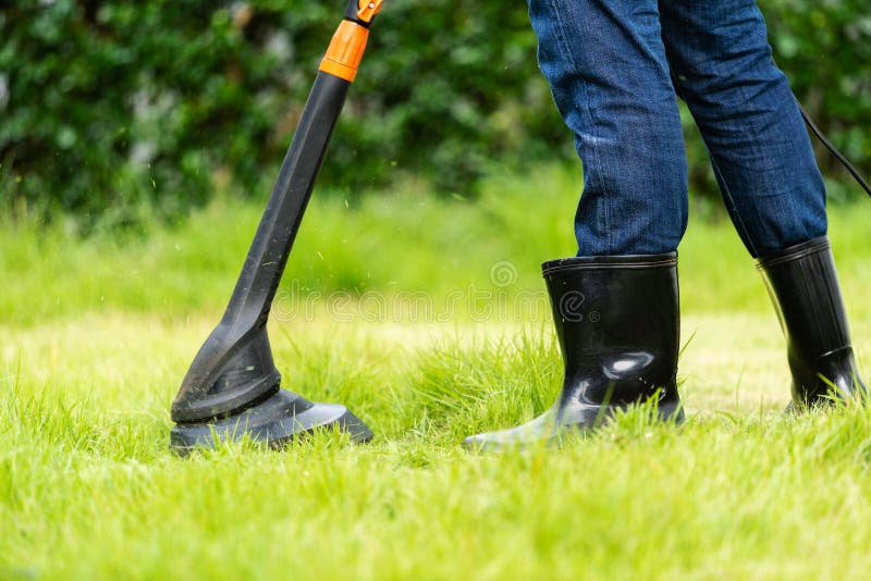 Worker Using a String Lawn Trimmer Mower Cutting Grass Stock Image ...