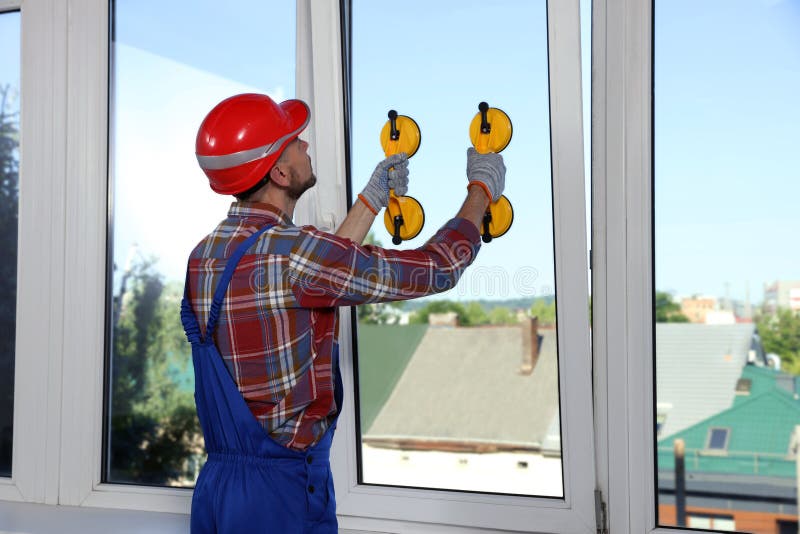 Worker Using Suction Lifters during Plastic Window Installation Indoors ...
