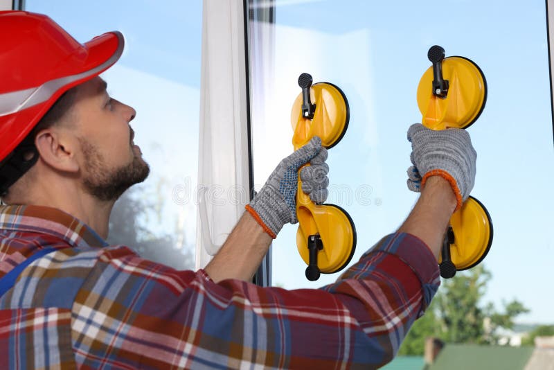 Worker Using Suction Lifters during Plastic Window Installation Indoors ...