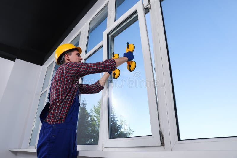 Worker Using Suction Lifters during Plastic Window Installation Indoors ...