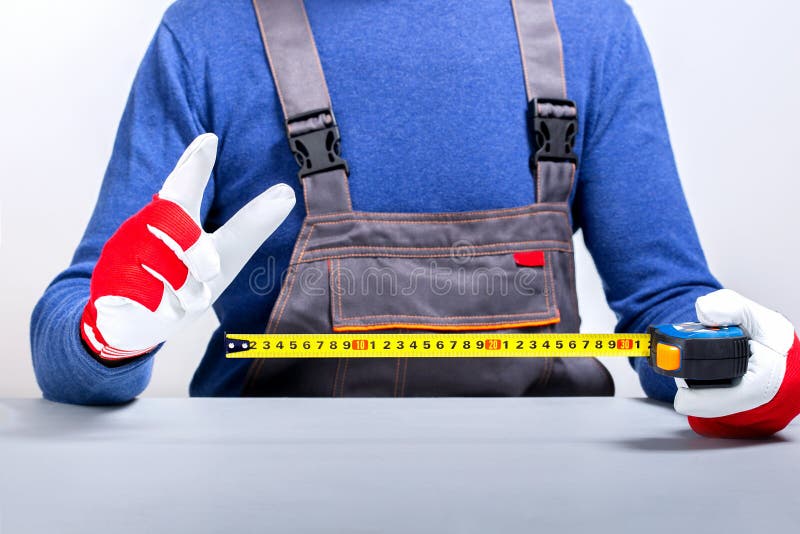 Worker Using Tape Measure stock image. Image of hand - 186070363