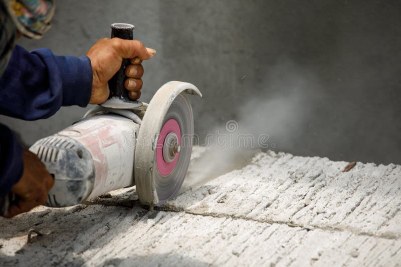 Worker Using Tool To Cut Concrete Floor with Blank Space on Right Stock ...