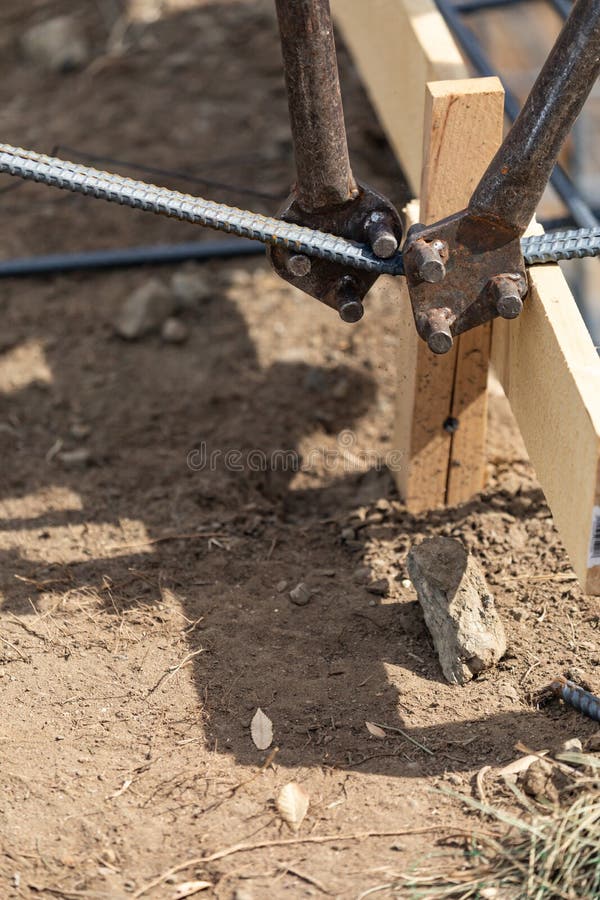 Worker Using Tools To Bend Steel Rebar at Construction Site Stock Image ...