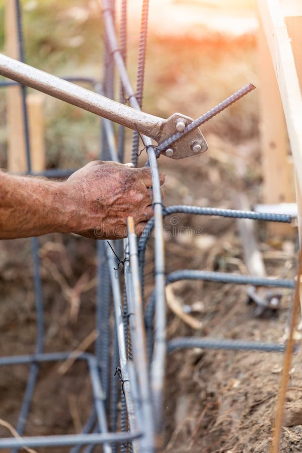 Worker Using Tools To Bend Steel Rebar at Construction Site Stock Image ...