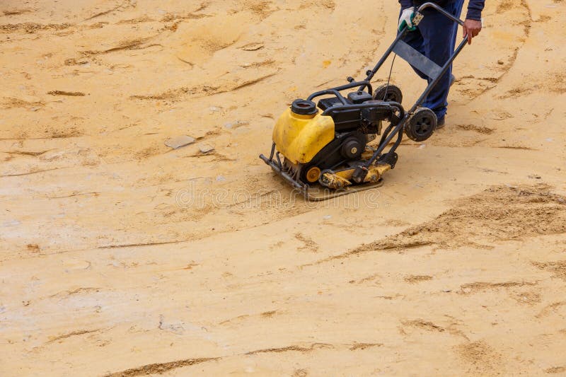 Worker Using Vibratory Plate Compactor for Compaction Sand during Path ...