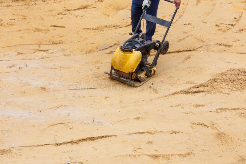 Worker Using Vibratory Plate Compactor for Compaction Sand during Path ...