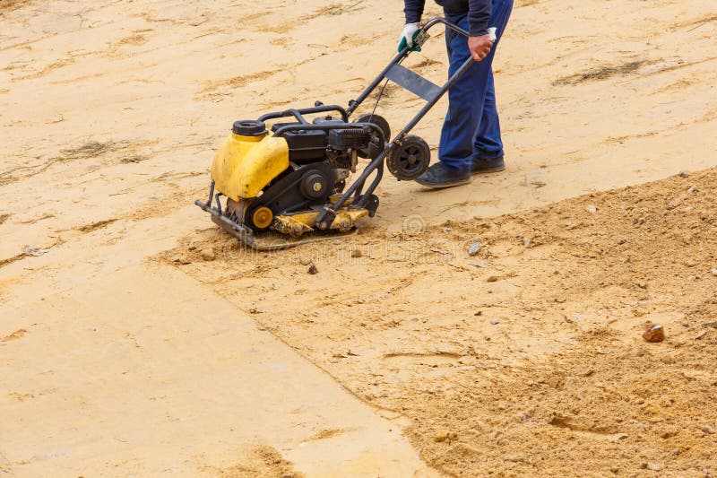 Worker Using Vibratory Plate Compactor for Compaction Sand during Path ...