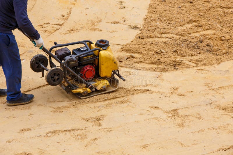 Worker Using Vibratory Plate Compactor for Compaction Sand during Path ...
