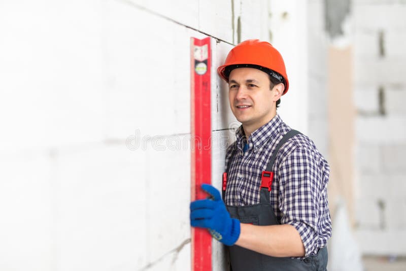 Worker Using Water Level Meter Measuring the Wall Builder Working with ...