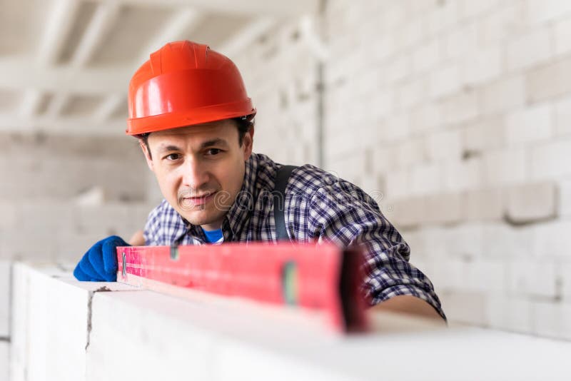 Worker Using Water Level Meter Measuring the Wall Builder Working with ...