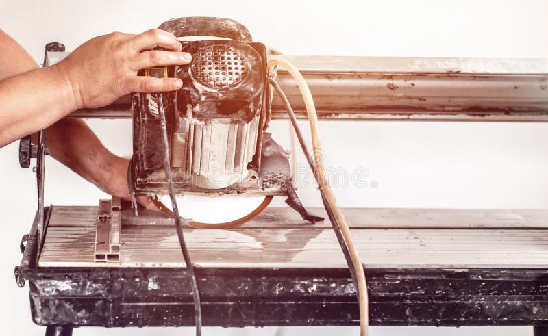 Worker Using Wet Tile Saw To Cut Wall Tile at Construction Site ...