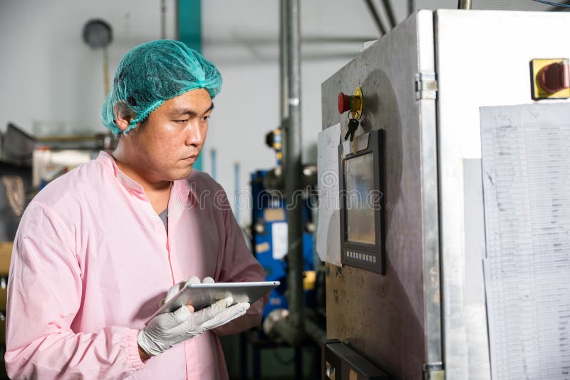 Worker Using Tablet in Beverage Factory Oversees Soda Water Filling ...