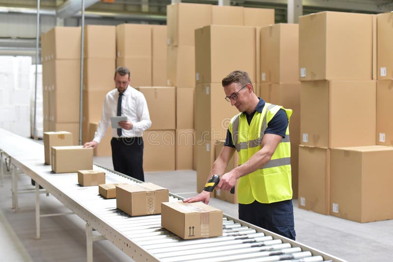 Worker in a Warehouse in the Logistics Sector Processing Packages on ...