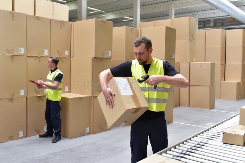 Worker in a Warehouse in the Logistics Sector Processing Packages on ...