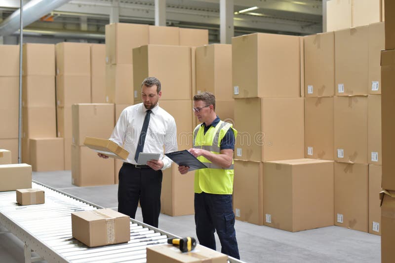 Worker in a Warehouse in the Logistics Sector Processing Packages on ...