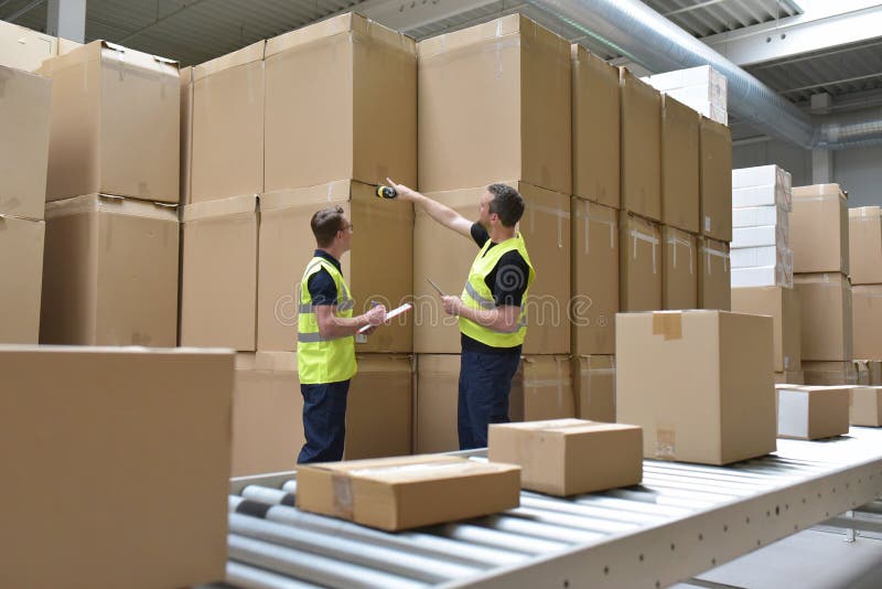 Worker in a Warehouse in the Logistics Sector Processing Packages on ...
