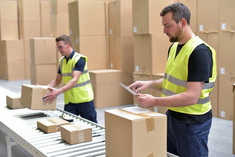 Worker in a Warehouse in the Logistics Sector Processing Packages on ...