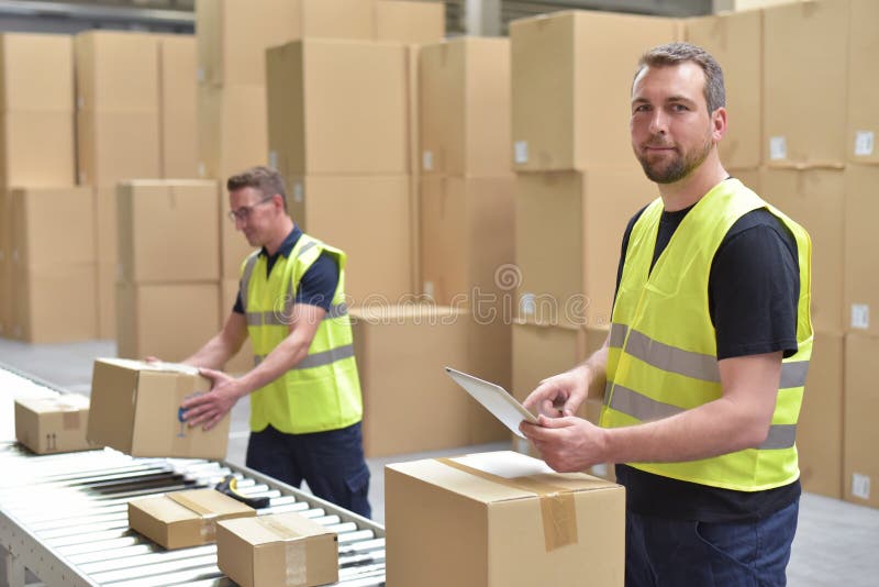 Worker in a Warehouse in the Logistics Sector Processing Packages on ...