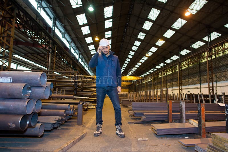 Worker in Warehouse Tipping Hardhat Stock Image - Image of building ...