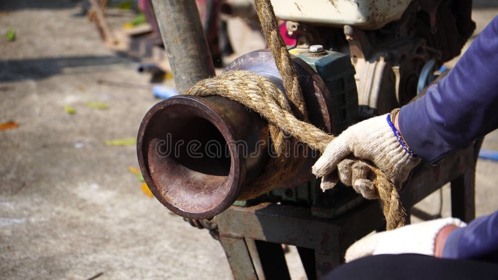 Worker Was Pulling the Rope from on Pulleys of Engine. Stock Image ...