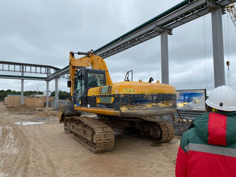Worker Watching Digger Moving Waste at Landfill Site Stock Image ...